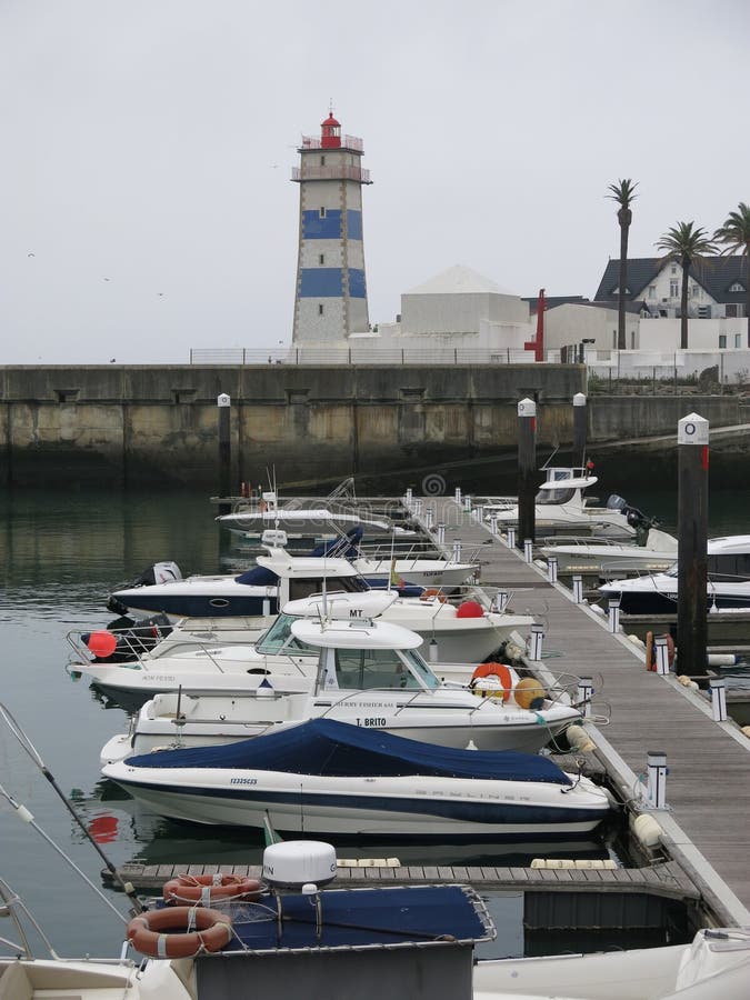 Lighthouse And Boats On Waterfront Stock Image - Image of jetty, boats ...