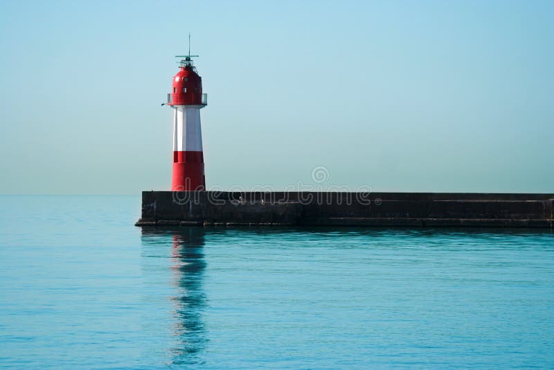Lighthouse on calm sea stock image. Image of water, pier - 4596943