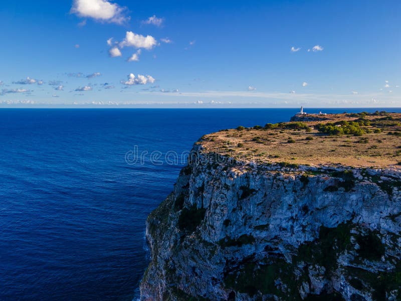 Lighthouse on Cliff Overlooking the Infinite Sea and Sky Stock Image ...
