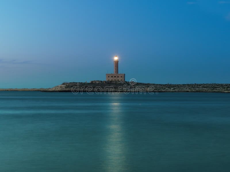 Lighthouse dusk dawn stock photo. Image of island, beach - 118103684