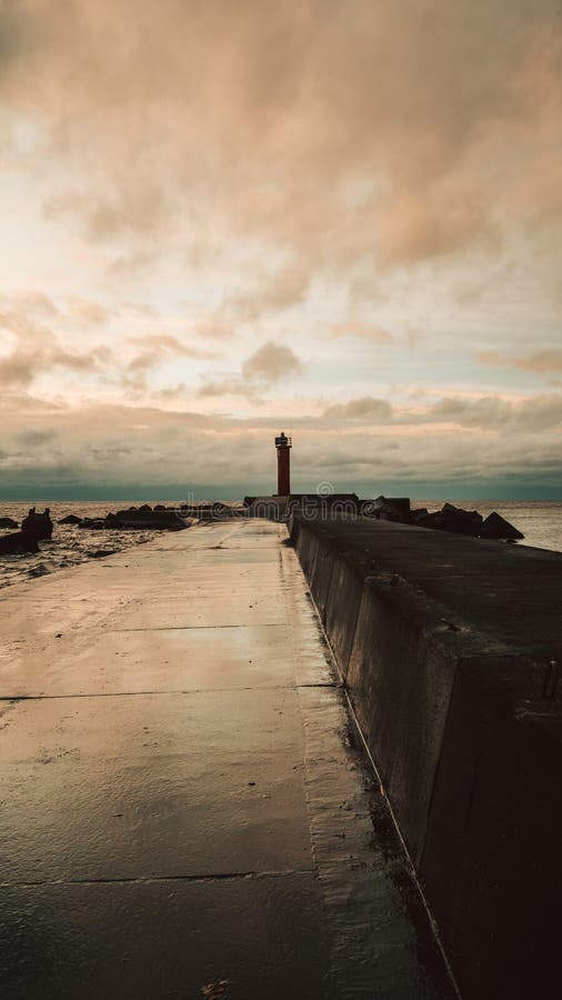 Lighthouse at the End of a Concrete Path Stock Photo - Image of path ...