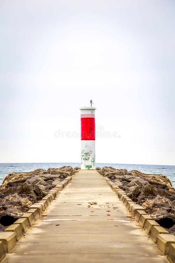Lighthouse at the End of a Pier Stock Photo - Image of ocean, coastline ...
