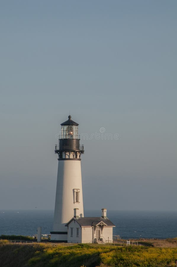 Lighthouse on a Grassy Cliff Overlooking the Ocean Stock Photo - Image ...