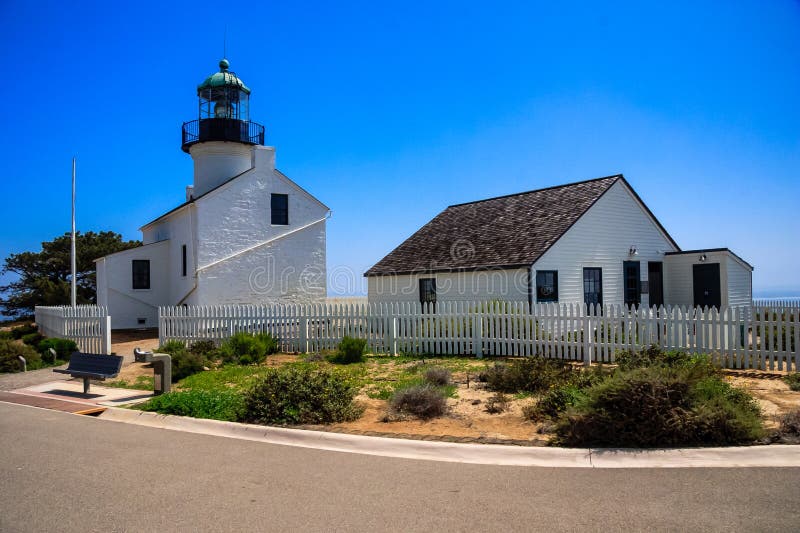 A Lighthouse and a House are on a Street Stock Photo - Image of park ...