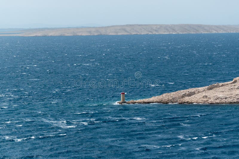 Lighthouse on island reef stock photo. Image of nautical - 335774304