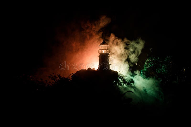 Lighthouse with Light Beam at Night with Fog. Old Lighthouse Standing ...