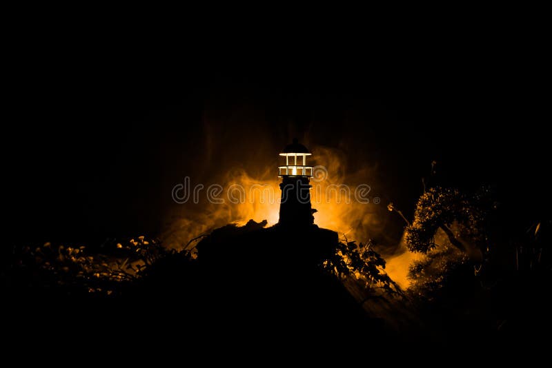 Lighthouse with Light Beam at Night with Fog. Old Lighthouse Standing ...