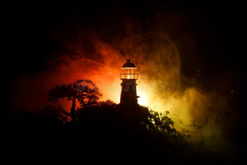 Lighthouse with Light Beam at Night with Fog. Old Lighthouse Standing ...