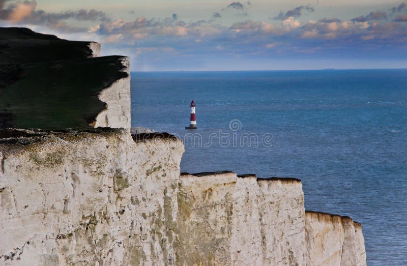 The Lighthouse is Located at the Edge of a Cliff on the Ocean Editorial ...