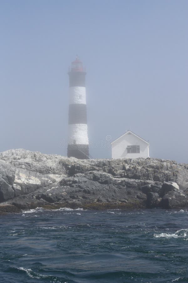 Lighthouse in the mist stock photo. Image of signaling - 20770054