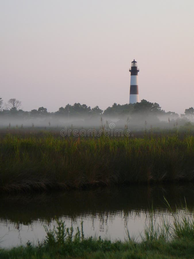 Lighthouse in the Morning Mist Stock Photo - Image of beam, firstlight ...