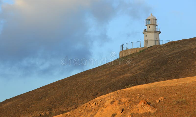 Lighthouse. the Movement of Clouds on the Mountain Meganom Stock Image ...