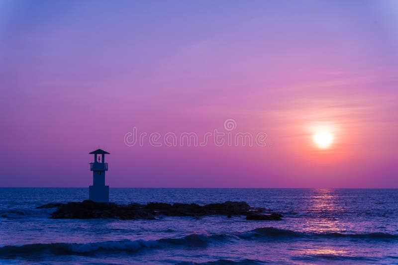 A Lighthouse in the Ocean during a Beautiful Sunset Stock Image - Image ...