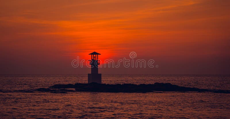A Lighthouse in the Ocean during a Beautiful Sunset Stock Photo - Image ...