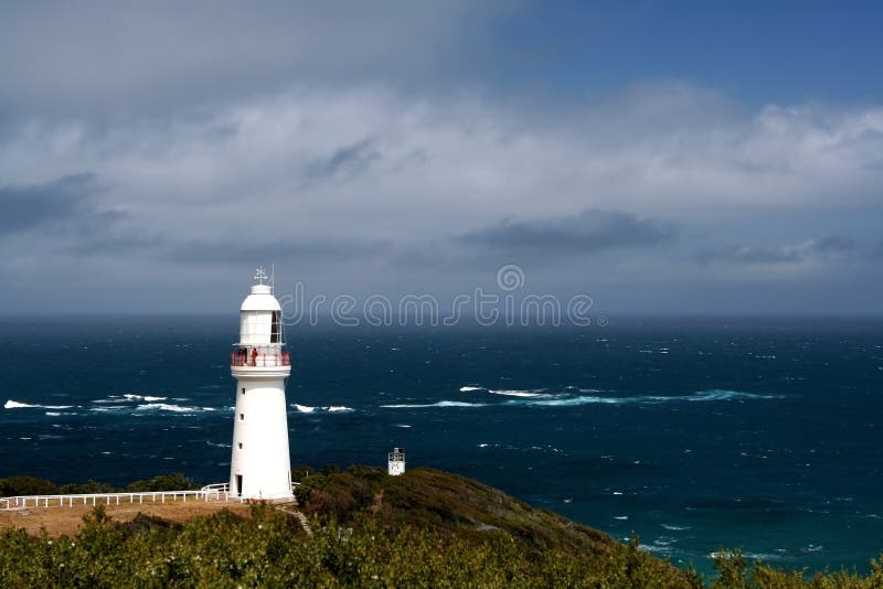 Lighthouse Overlooking Rough Blue Ocean Stock Photo - Image of cape ...