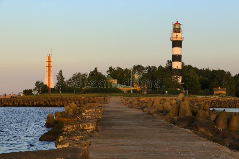 Lighthouse with a Pier at Sunrise Stock Image - Image of port, cloudy ...