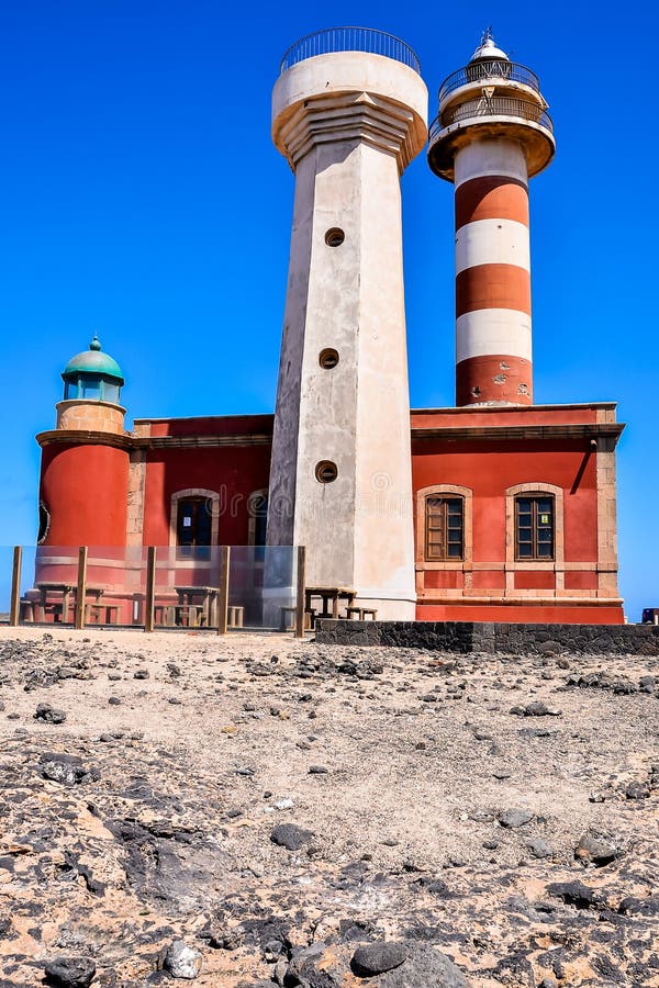 A Lighthouse with a Red and White Striped Tower Stock Photo - Image of ...