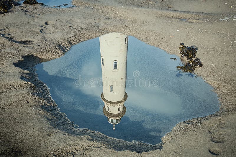 A Lighthouse Reflecting in a Still Tidal Pool at Low Tide. Picture ...