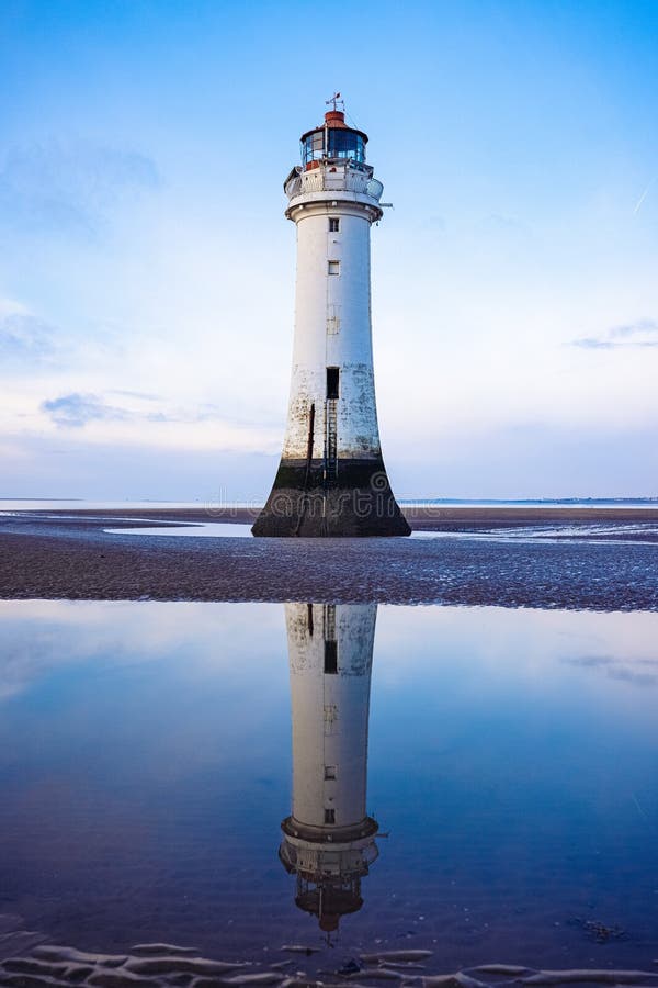 Lighthouse Reflects in the Water Stock Photo - Image of alone ...