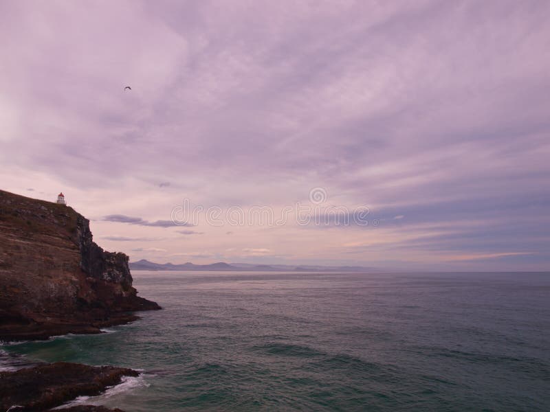 Lighthouse on rock stock photo. Image of clouds, wildlife - 22654900