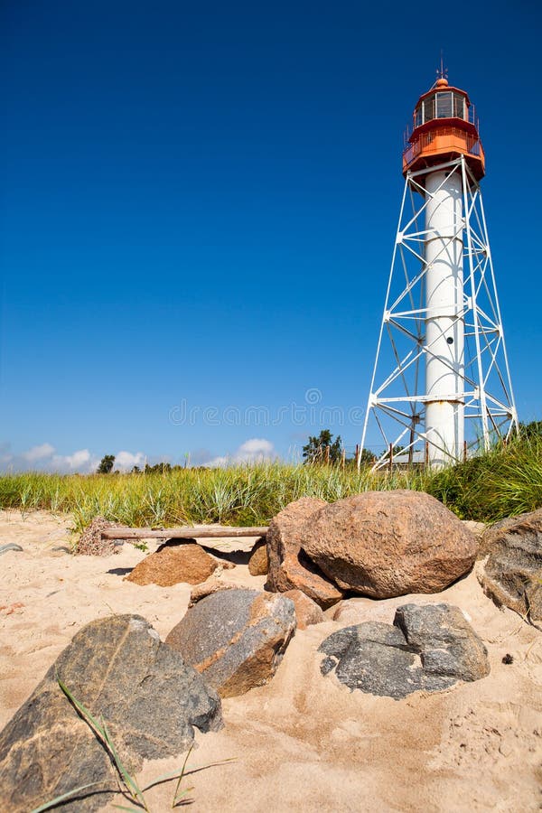 Lighthouse with rocks stock photo. Image of skies, scenic - 34422594