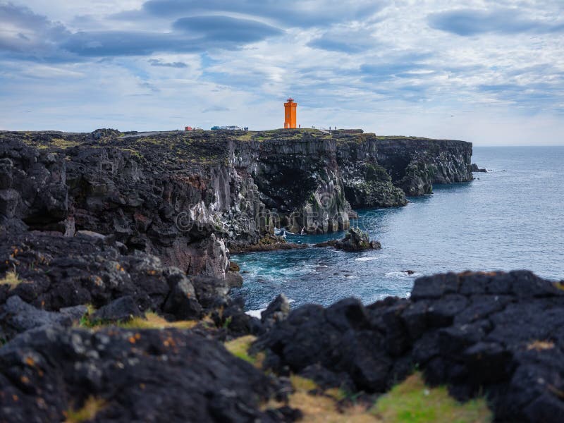 Lighthouse on the Rocks in the Iceland. High Rocks and Lighthouse at ...