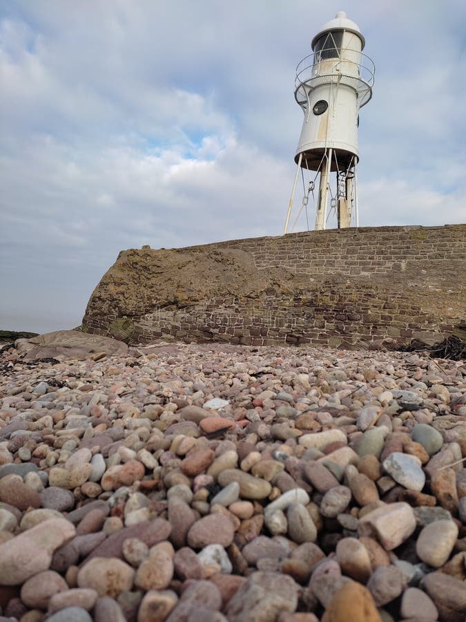 Lighthouse by the Seaside with Stone Beach Relaxing Atmosphere Stock ...