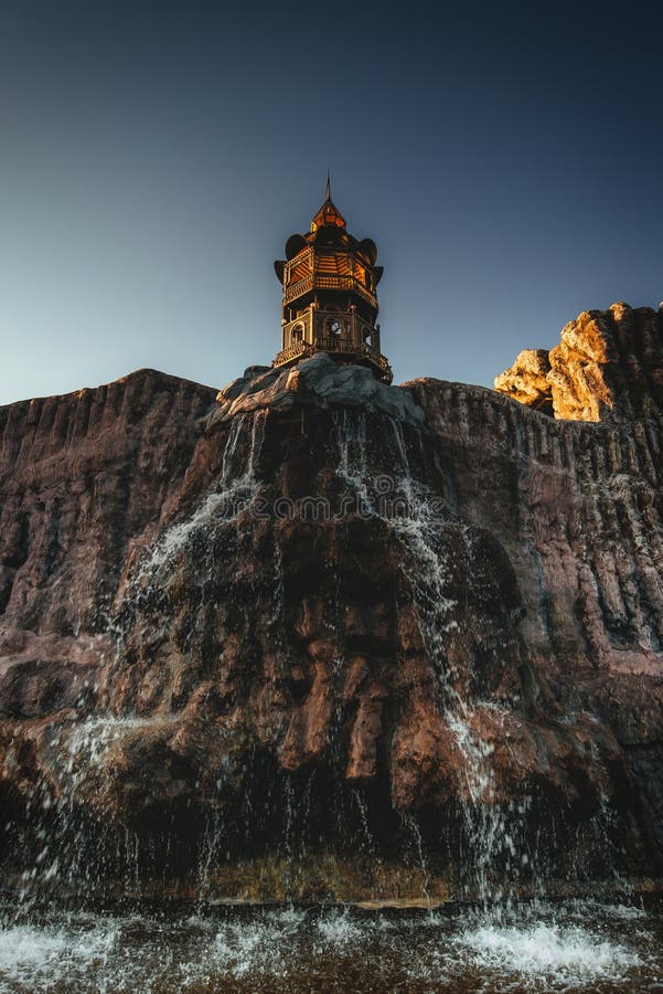 A Lighthouse in the Setting Sun. a Lighthouse and an Abandoned Ship in ...