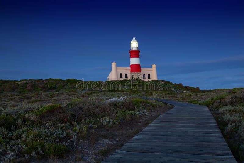 Lighthouse Shining Light in Darkness with Dark Blue Clouds Stock Photo ...