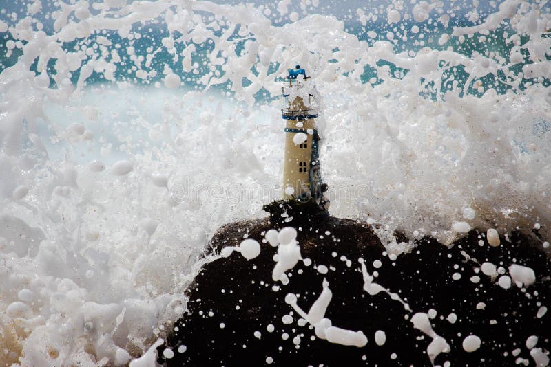 Lighthouse Splashing Water on the Rocks Stock Photo - Image of wave ...