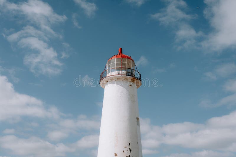 A Lighthouse is Standing Tall in the Sky Stock Photo - Image of white ...