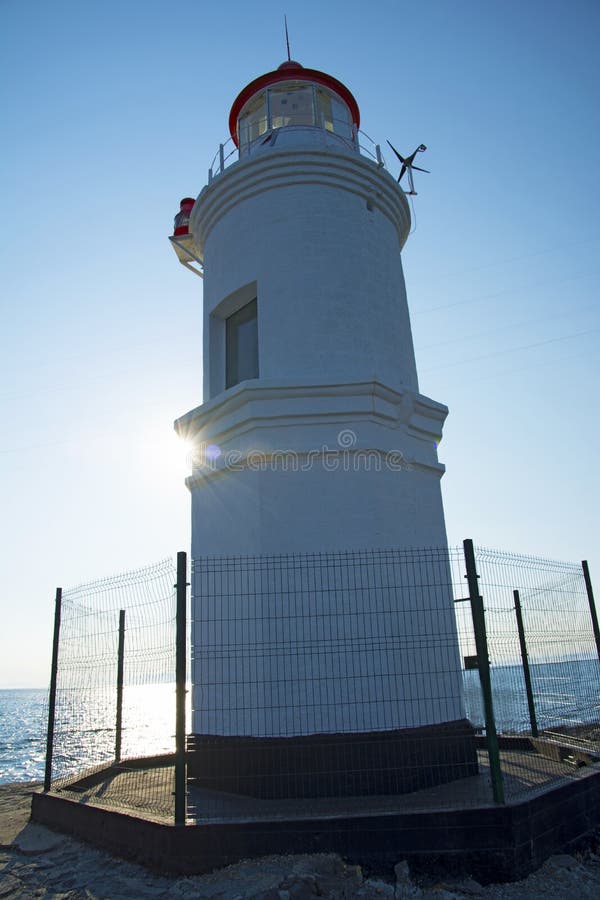 A Lighthouse Stands on a Raised Platform in the Middle of the Sea Stock ...