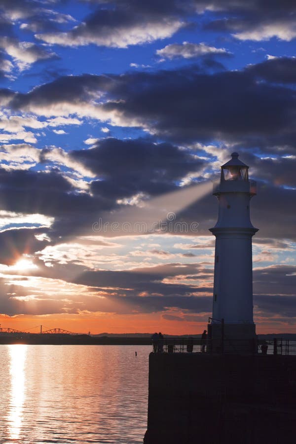 Lighthouse With Light Beam At Sunset Stock Photo - Image of keeper ...