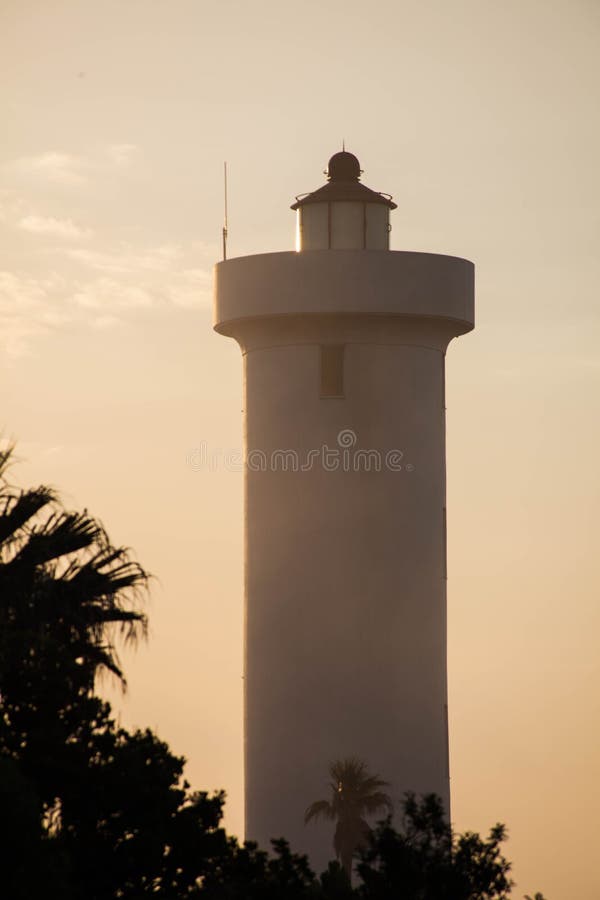Lighthouse at Sunset stock image. Image of silhouetted - 56108477