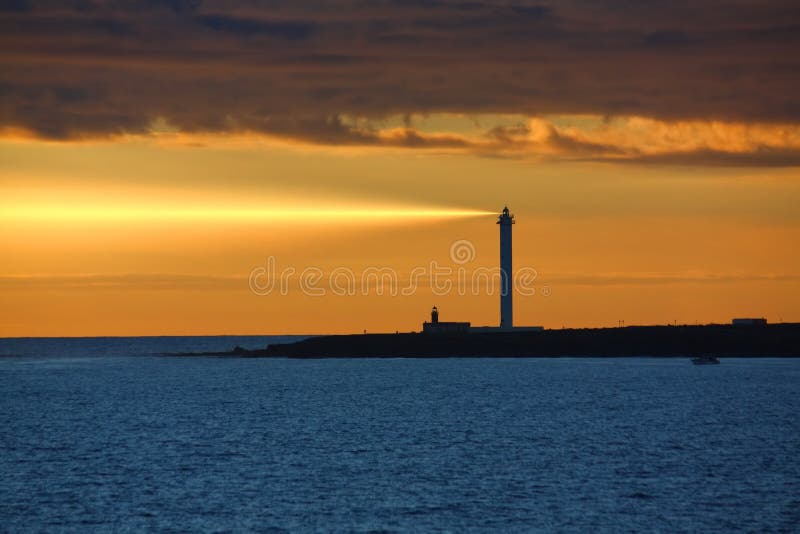 Lighthouse in Sunset with Ray of Light Stock Image - Image of symbolic ...