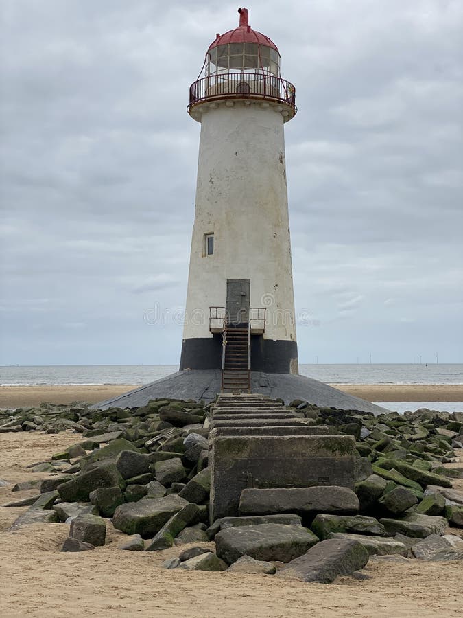 Lighthouse on the Beach Overlooking Ocean Stock Photo - Image of ...
