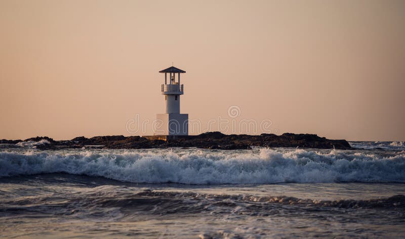 Lighthouse Surrounded by Water and Cloudy Sunset Sky Stock Photo ...