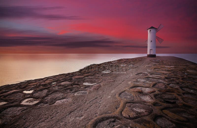 Lighthouse Windmill with Dramatic Sunset Sky Stock Photo - Image of ...