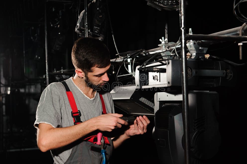 The Lighting Engineer Adjusts the Lights on the Stage. Stock Photo ...