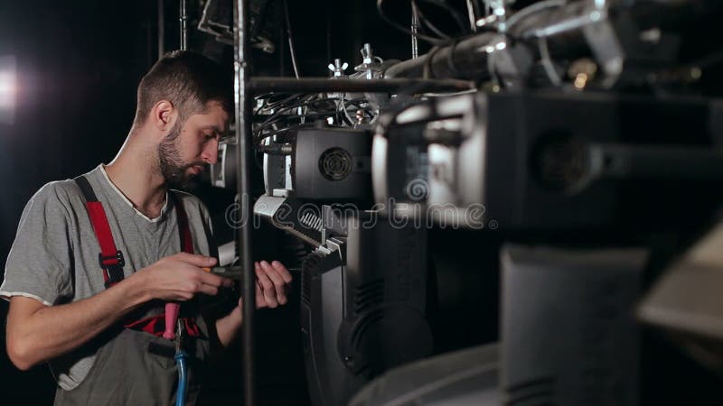 Man Engineer Repairs Lighting Equipment on Stage. Stock Video - Video ...