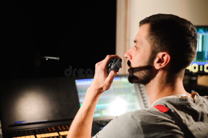 A Lighting Engineer Works with Lights Technicians Control on the ...