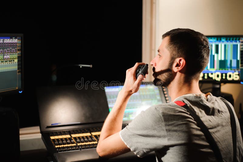 A Lighting Engineer Works with Lights Technicians Control on the ...