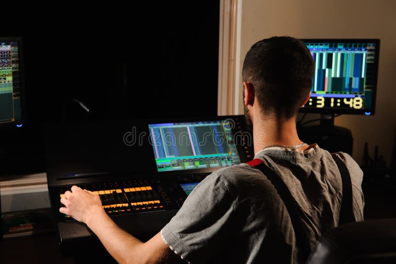 A Lighting Engineer Works with Lights Technicians Control on the ...