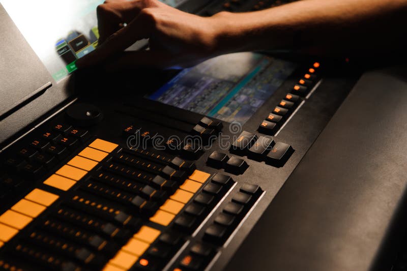 A Lighting Engineer Works with Lights Technicians Control on the ...