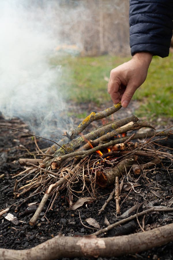 Man is Lighting a Fire in the Forest Stock Image - Image of flames, hand: 347364617