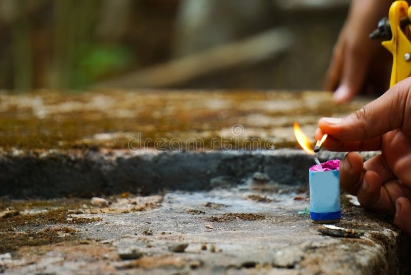 Lighting a firecracker. stock photo. Image of crackers - 186489238