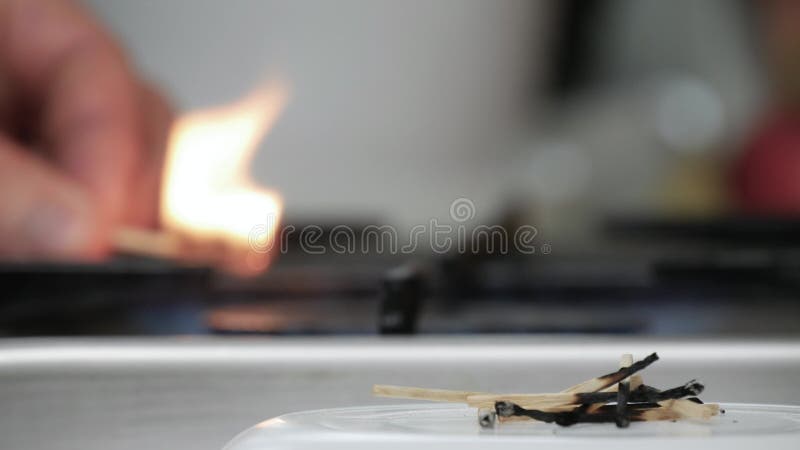 Lighting the Flame of the Kitchen Stove Opening the Gas and Using a Lit ...