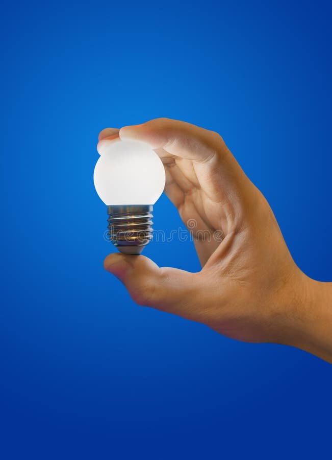 Lighting Lamp In Hand On Blue Stock Photo - Image of blue, electricity ...