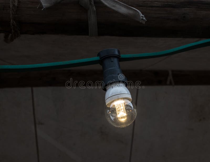 Lighting Light Bulb on the Cable at Dusk Stock Photo - Image of glowing ...