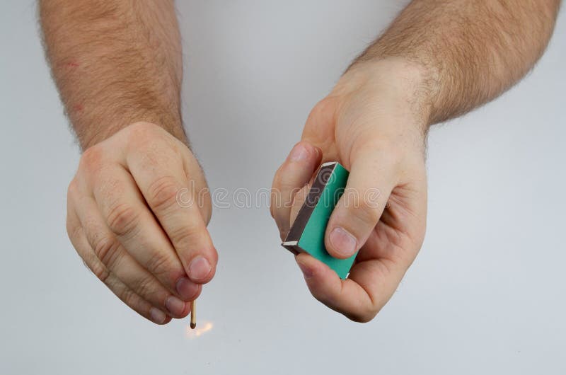 Lighting a Match. Close-up of Hands, Matchbox and Match on Light-gray ...
